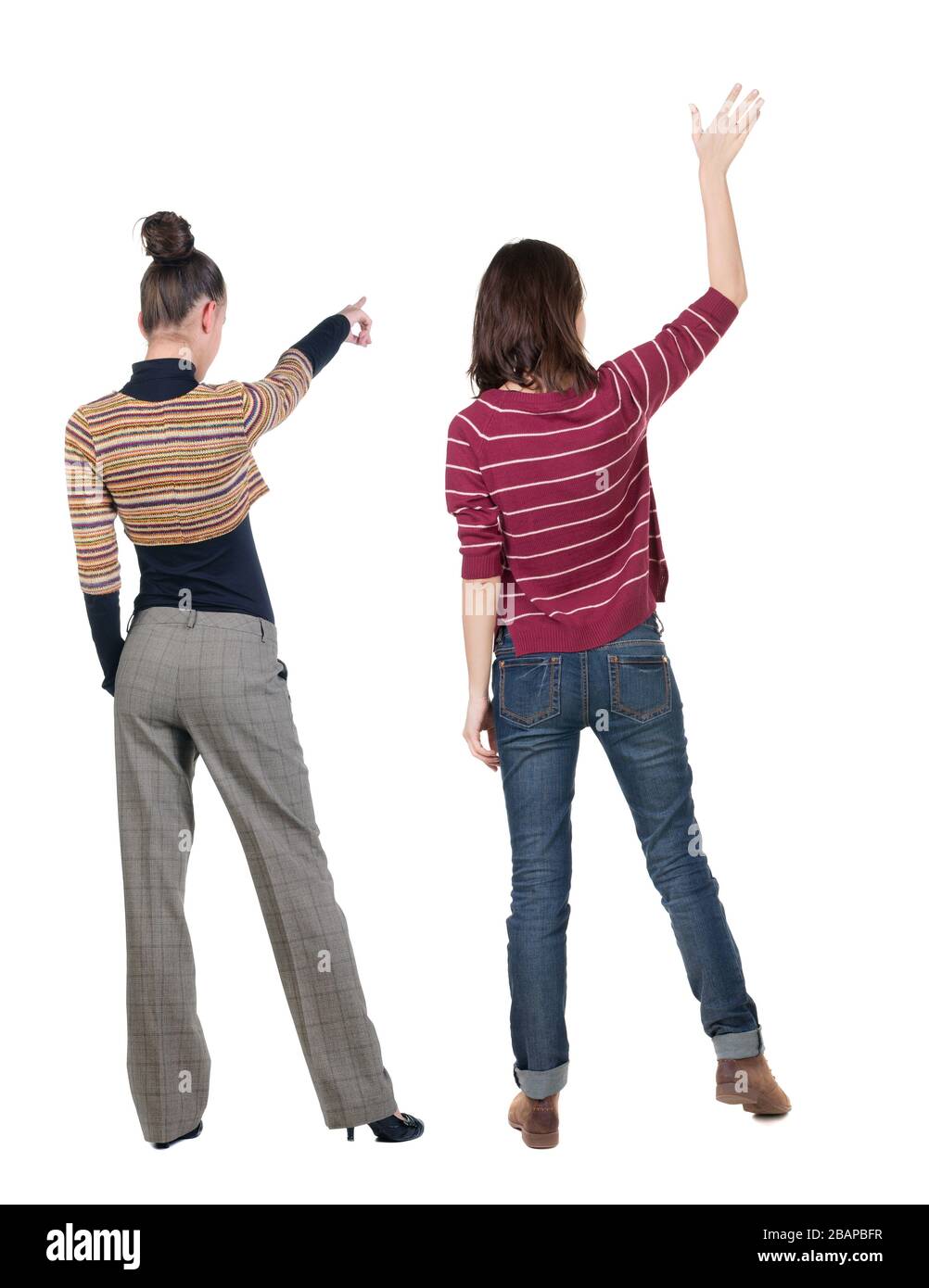 Back view of two pointing girl in sweater. Rear view people collection ...