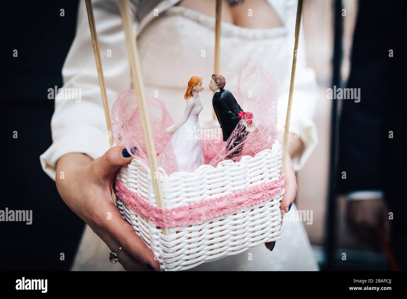 figurines of bride and groom kissing as miniature Stock Photo - Alamy