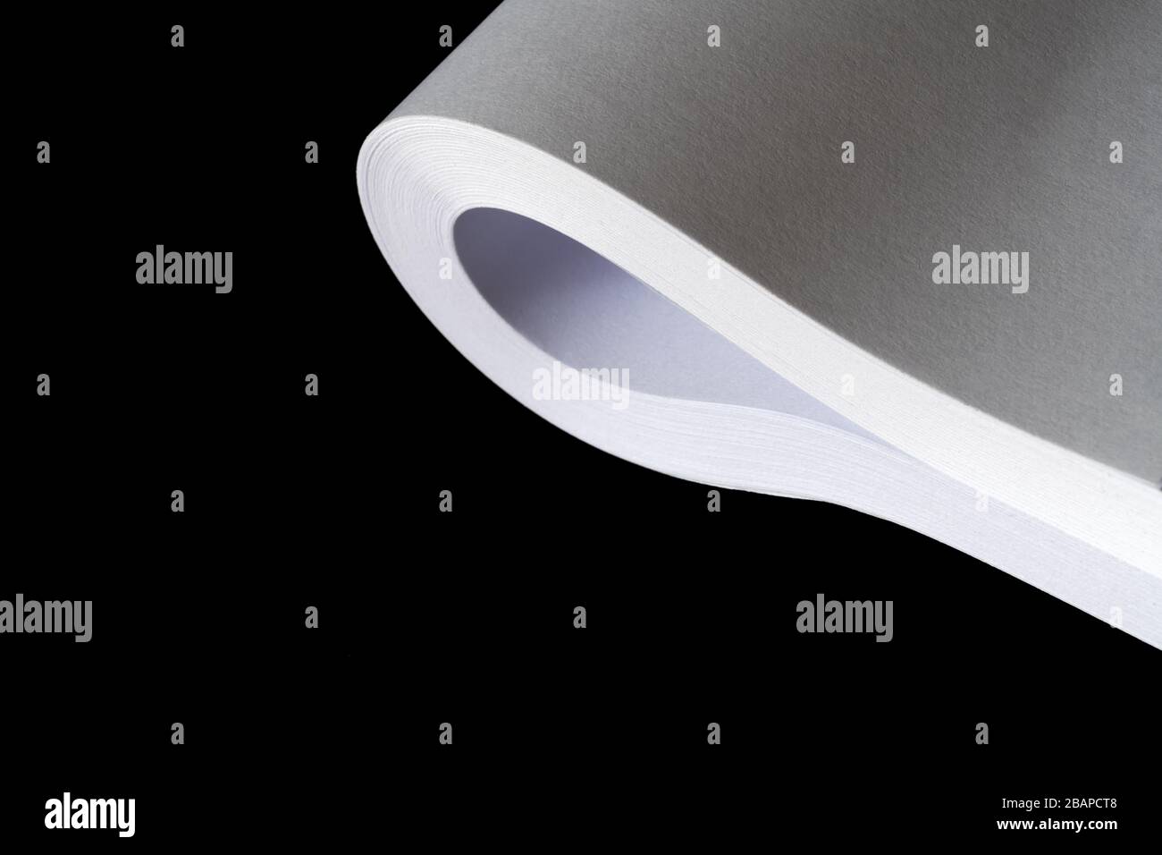 Multiple sheets of rolled A4 paper stack (a4 paper ream) on black ...