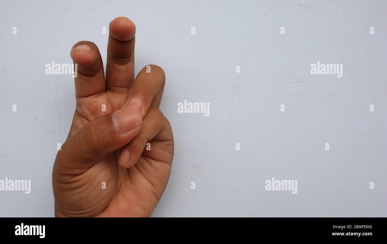 Left hand photographed with the meaning of a symbol and white ...