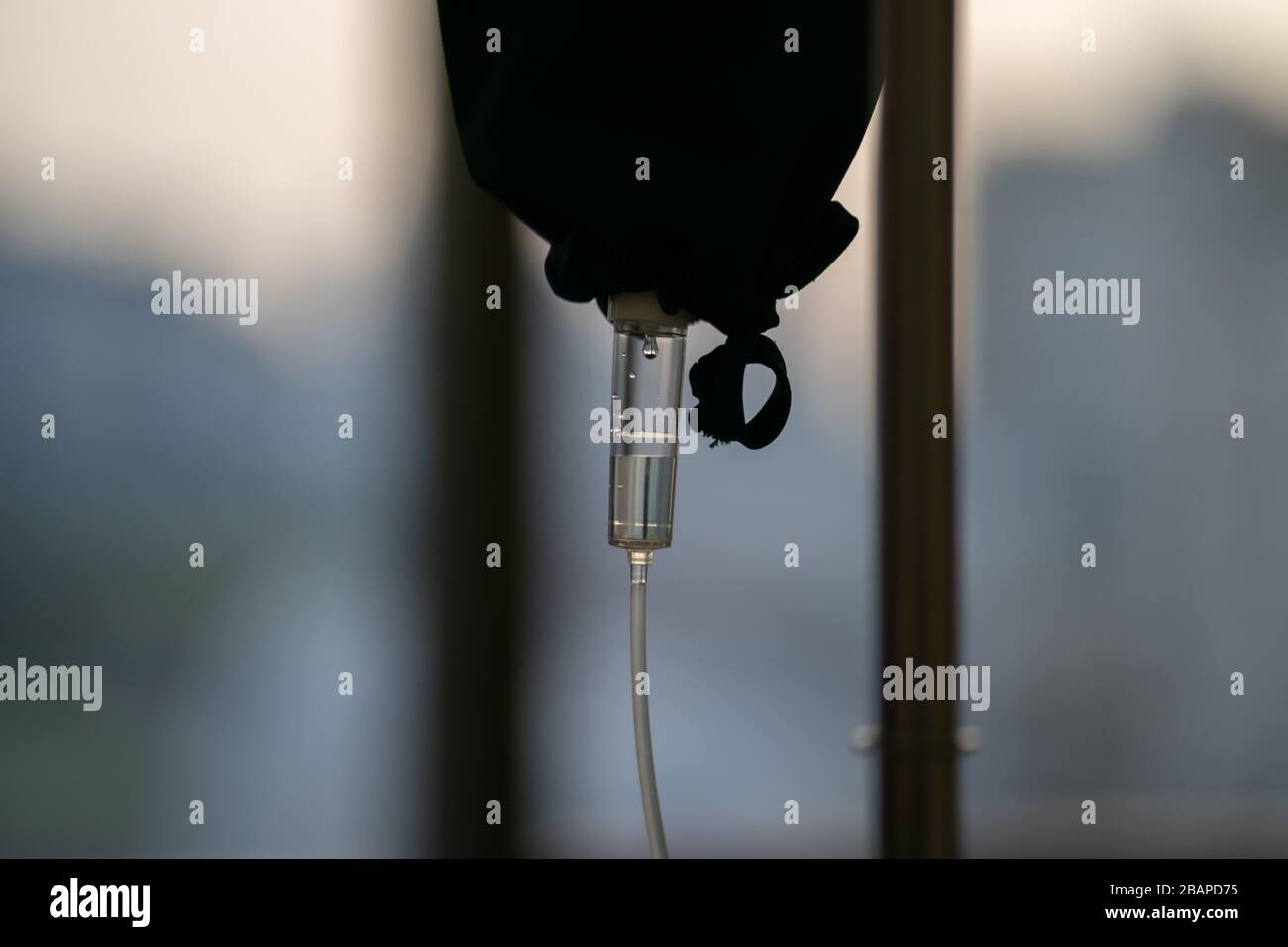 close up to the medical tool, saline drip in the dark silhouette theme ...