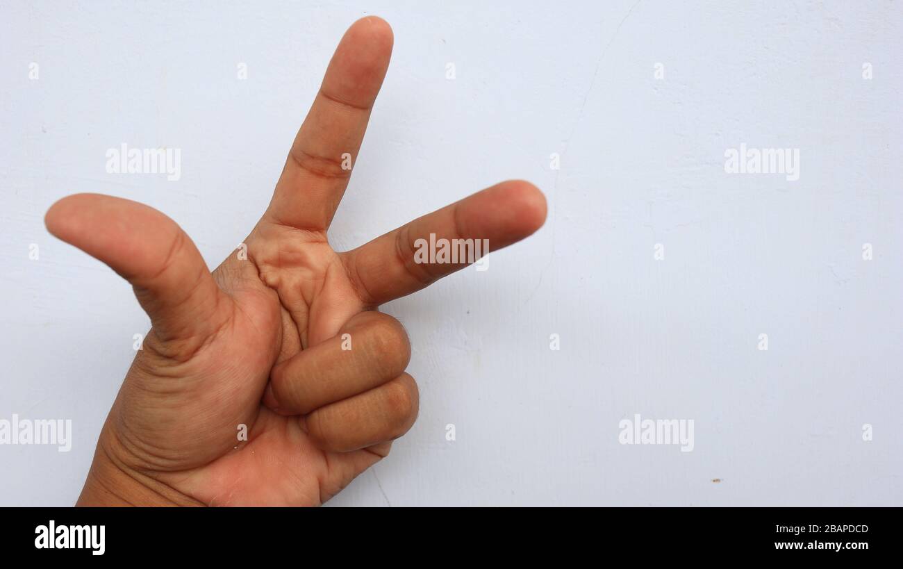 Left hand photographed with the meaning of a symbol and white ...