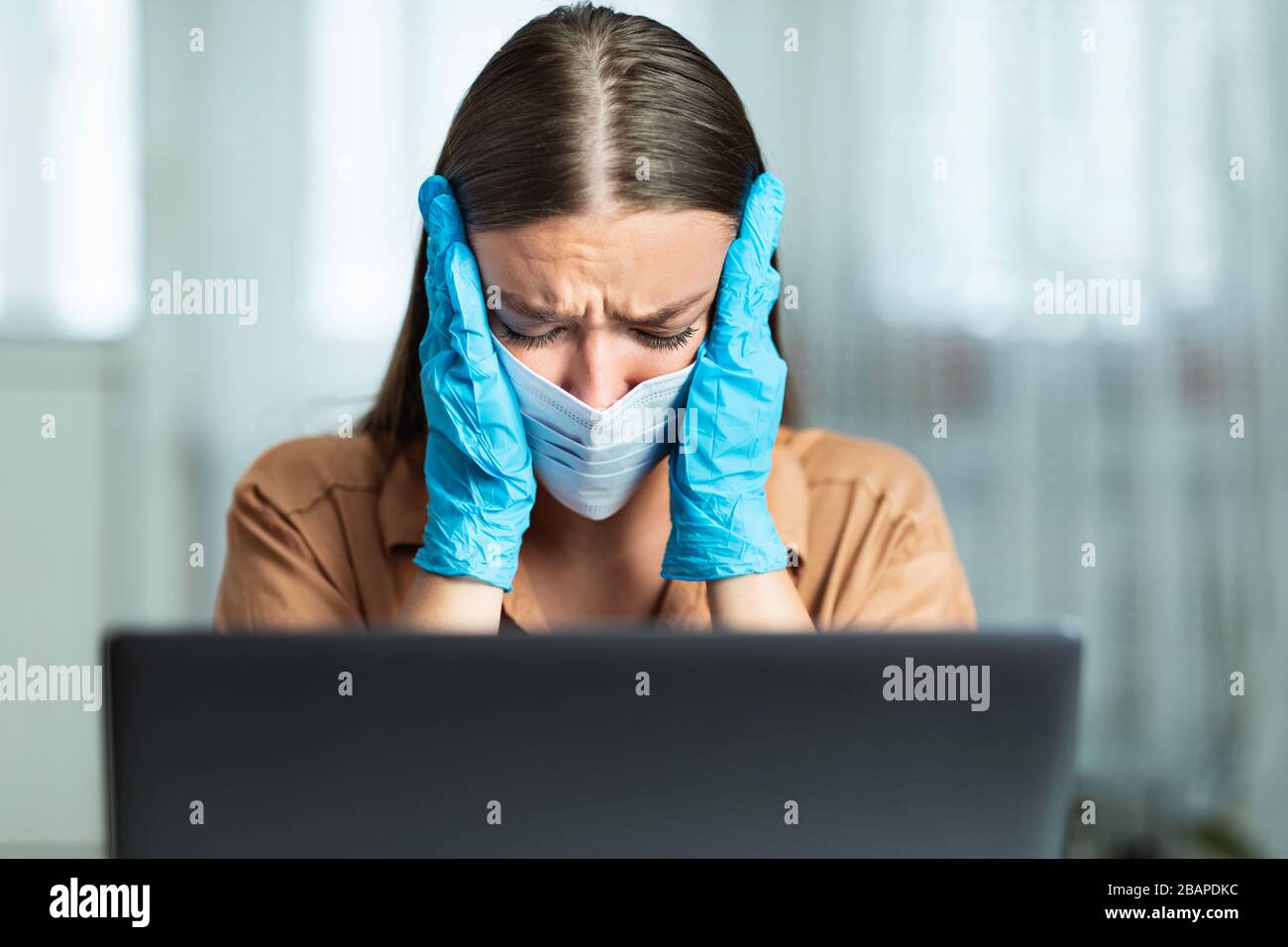 Girl in quarantine wearing mask and crying about news Stock Photo - Alamy