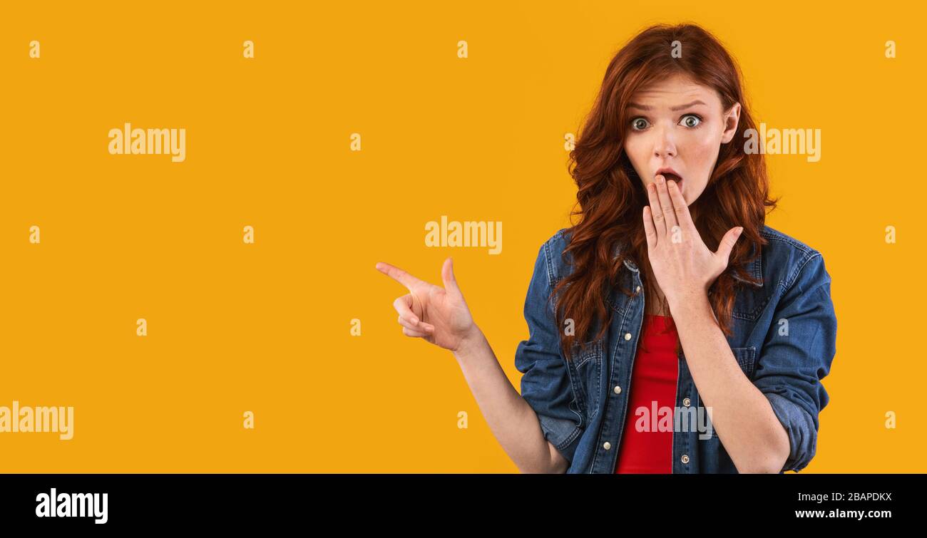Shocked Girl Pointing Fingers Aside Covering Mouth On Yellow Background ...