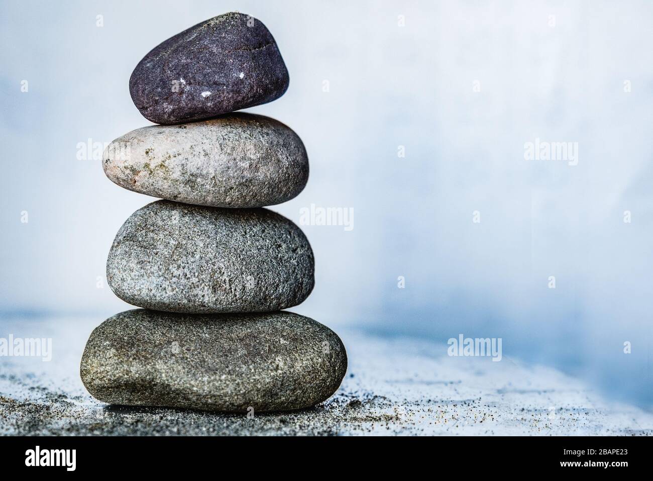 Four colored pebble Stones stacked on bright white background Stock ...