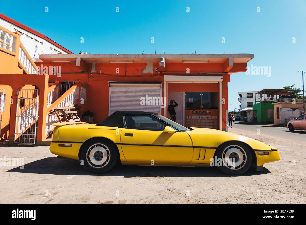 an old yellow 1980s Chevrolet Corvette C4 convertible parked in ...