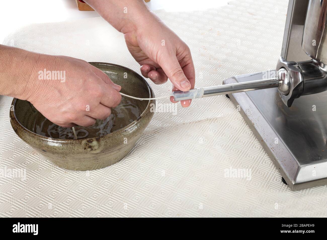 meat mincer in front of white background Stock Photo - Alamy