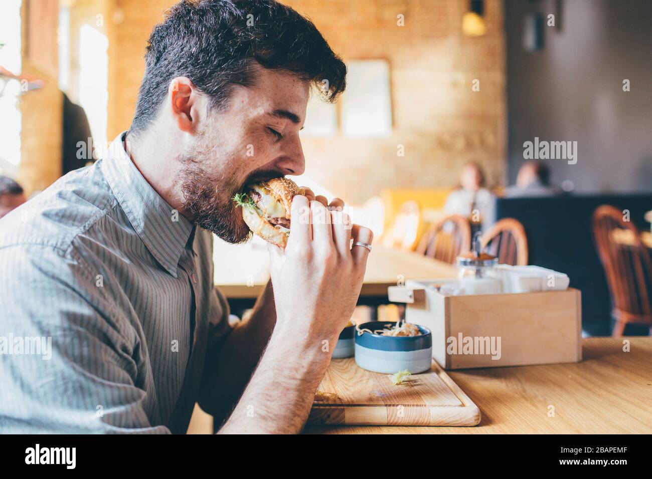 Man is eating in a restaurant and enjoying delicious food Stock Photo ...