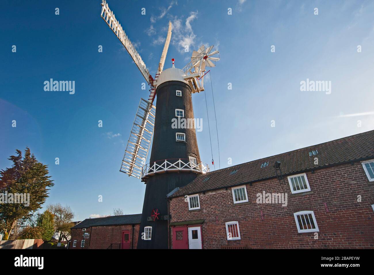 Old traditional working windmill in rural countryside landscape with ...