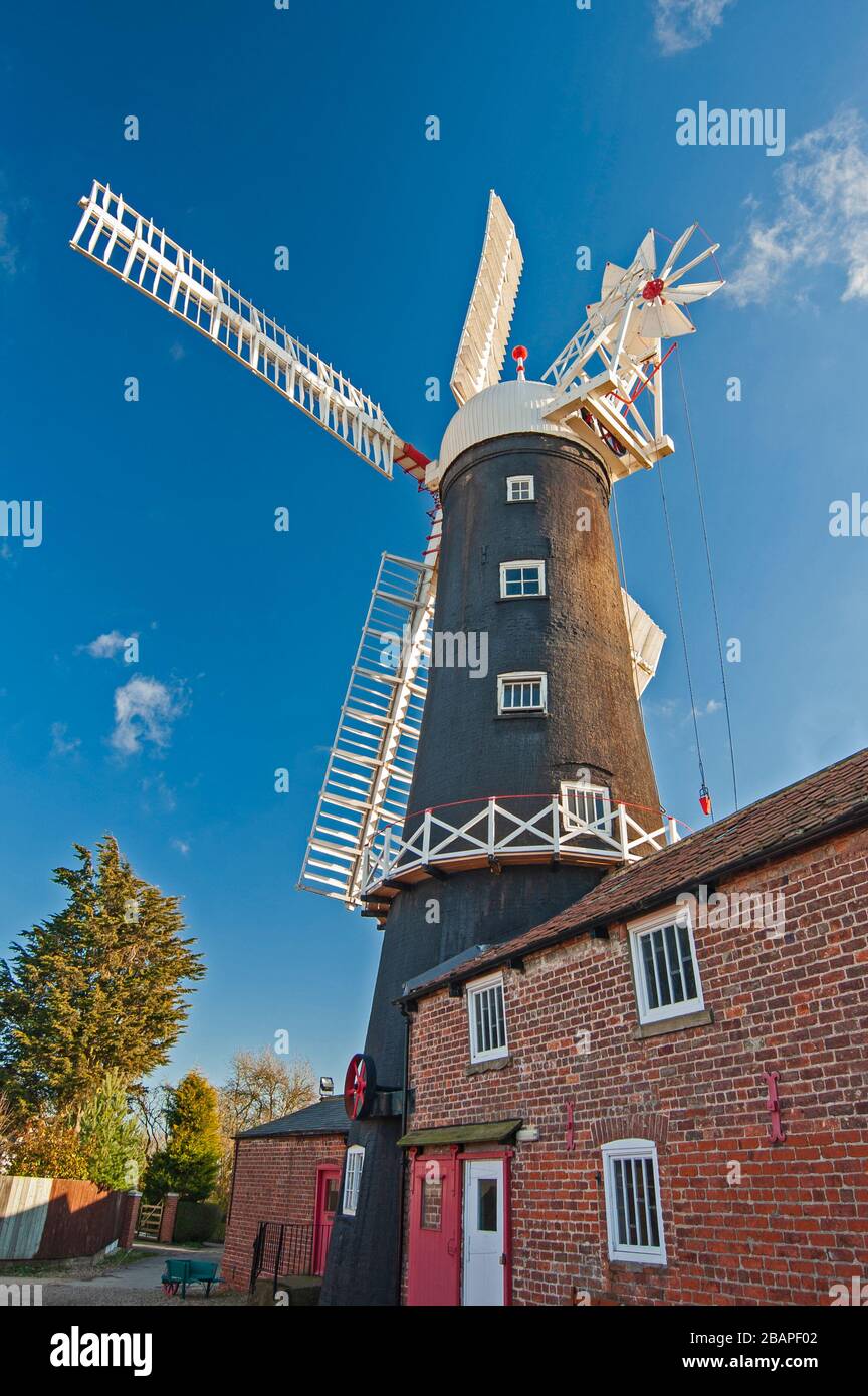 Old traditional working windmill in rural countryside landscape with ...