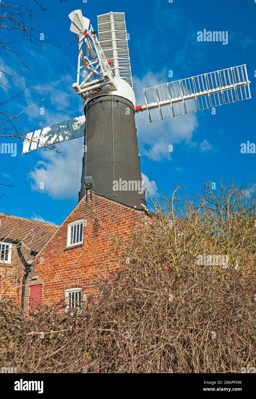 Old traditional working windmill in rural countryside landscape with ...