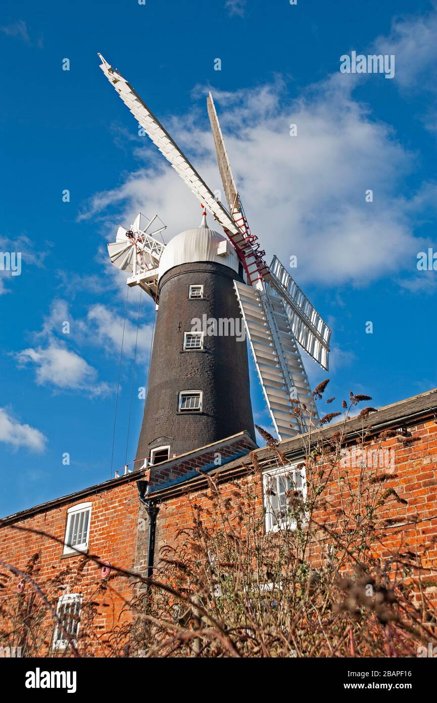 Old traditional working windmill in rural countryside landscape with ...