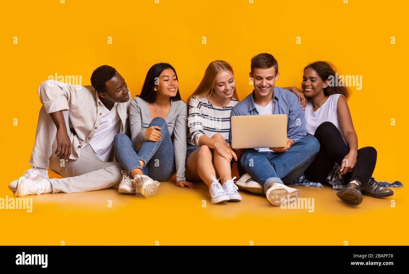 International group of teenagers using laptop together Stock Photo - Alamy