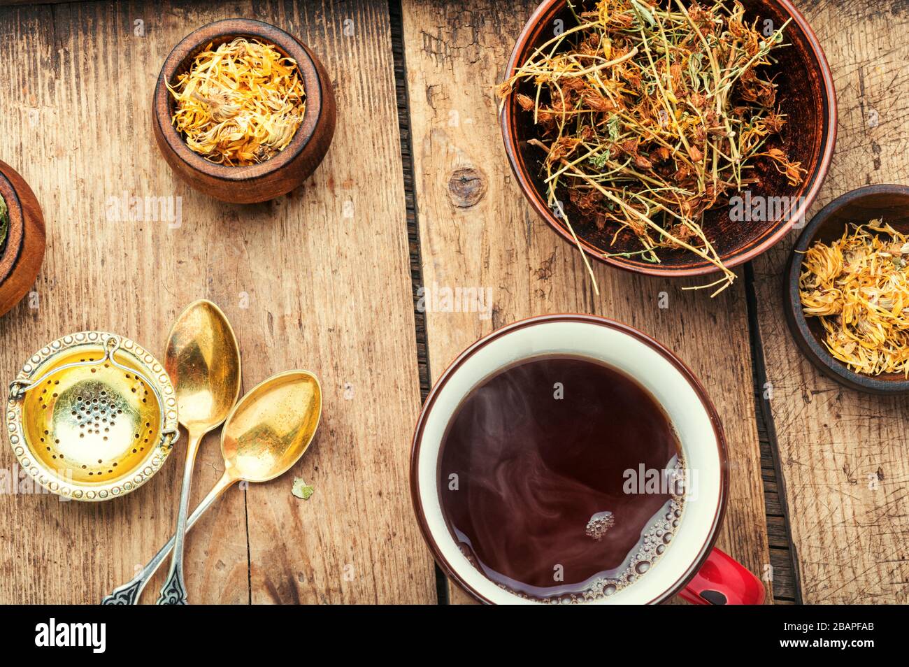 Cup with useful tea from medicinal herbs on a wooden background Stock ...