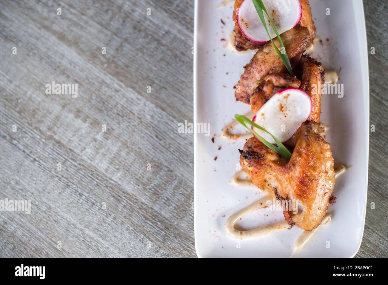 Chicken on entree on rustic table Stock Photo - Alamy