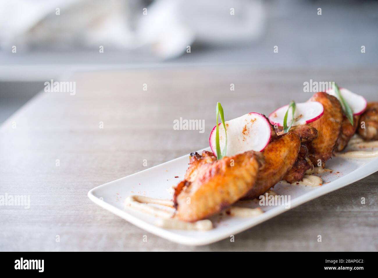 Chicken on entree on rustic table Stock Photo - Alamy
