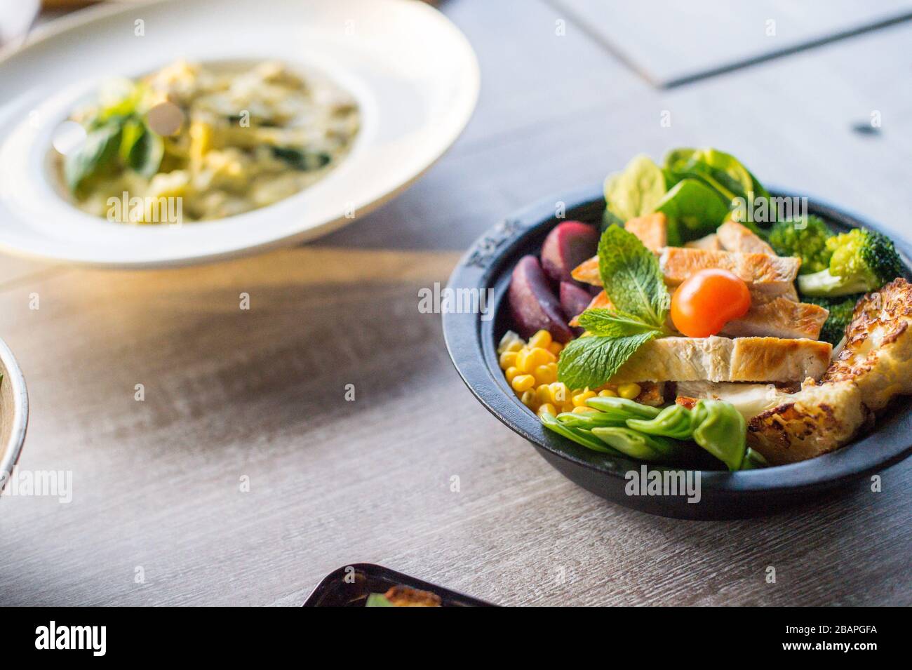 Chicken on entree on rustic table Stock Photo - Alamy