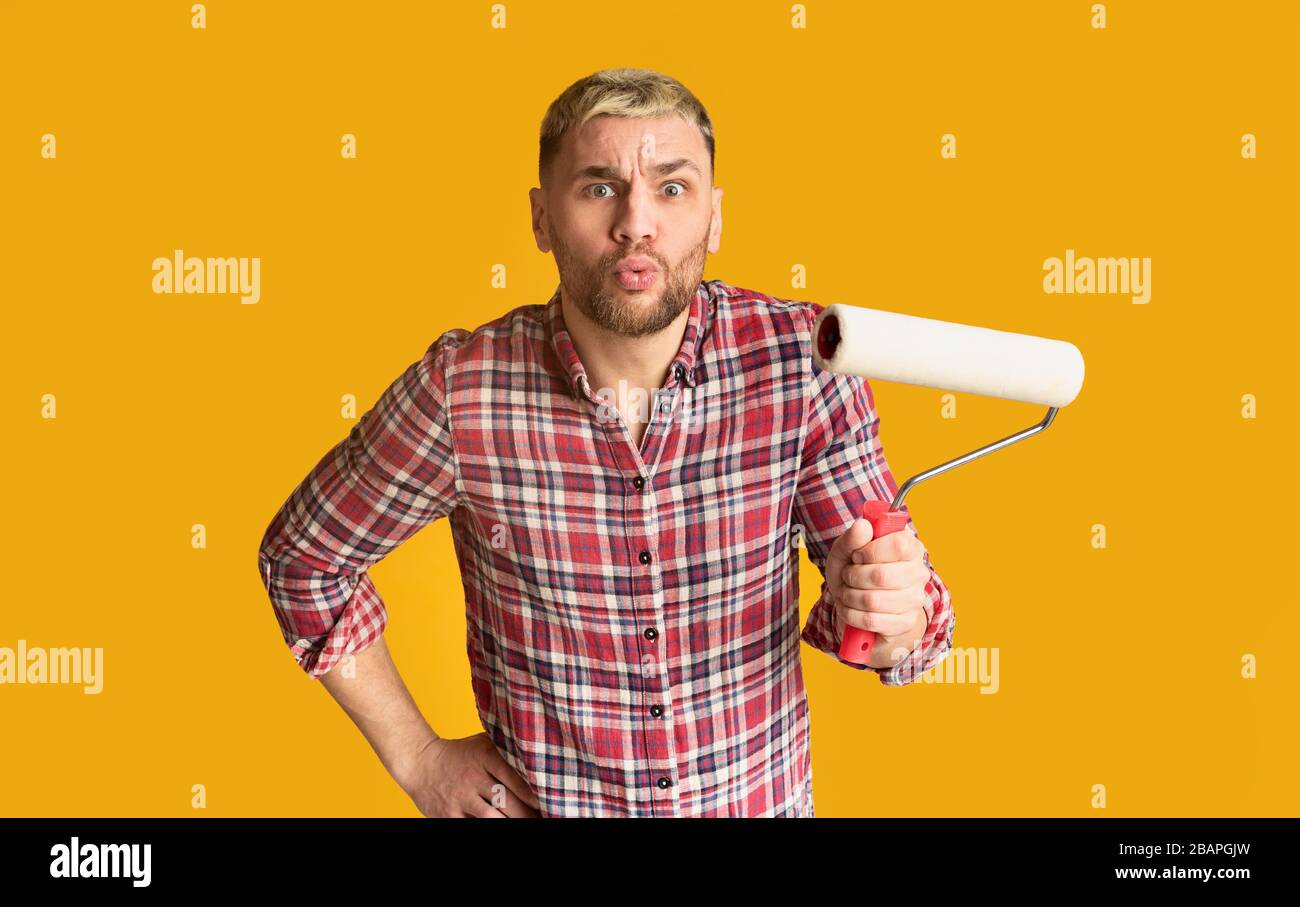 Homemade repair concept. Man with roller in his hand Stock Photo - Alamy