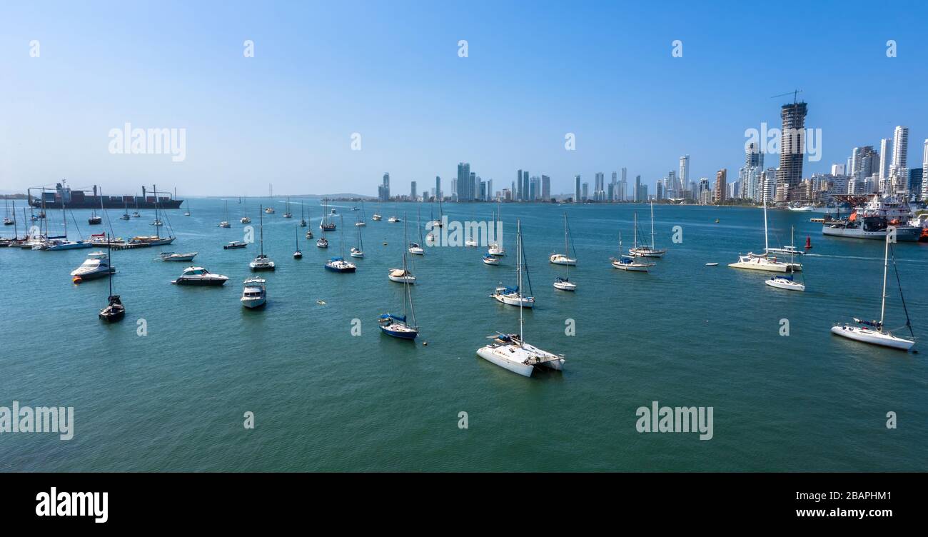 Cargo ship left port in Cartagena, Colombia. Beautiful yachts drift in ...