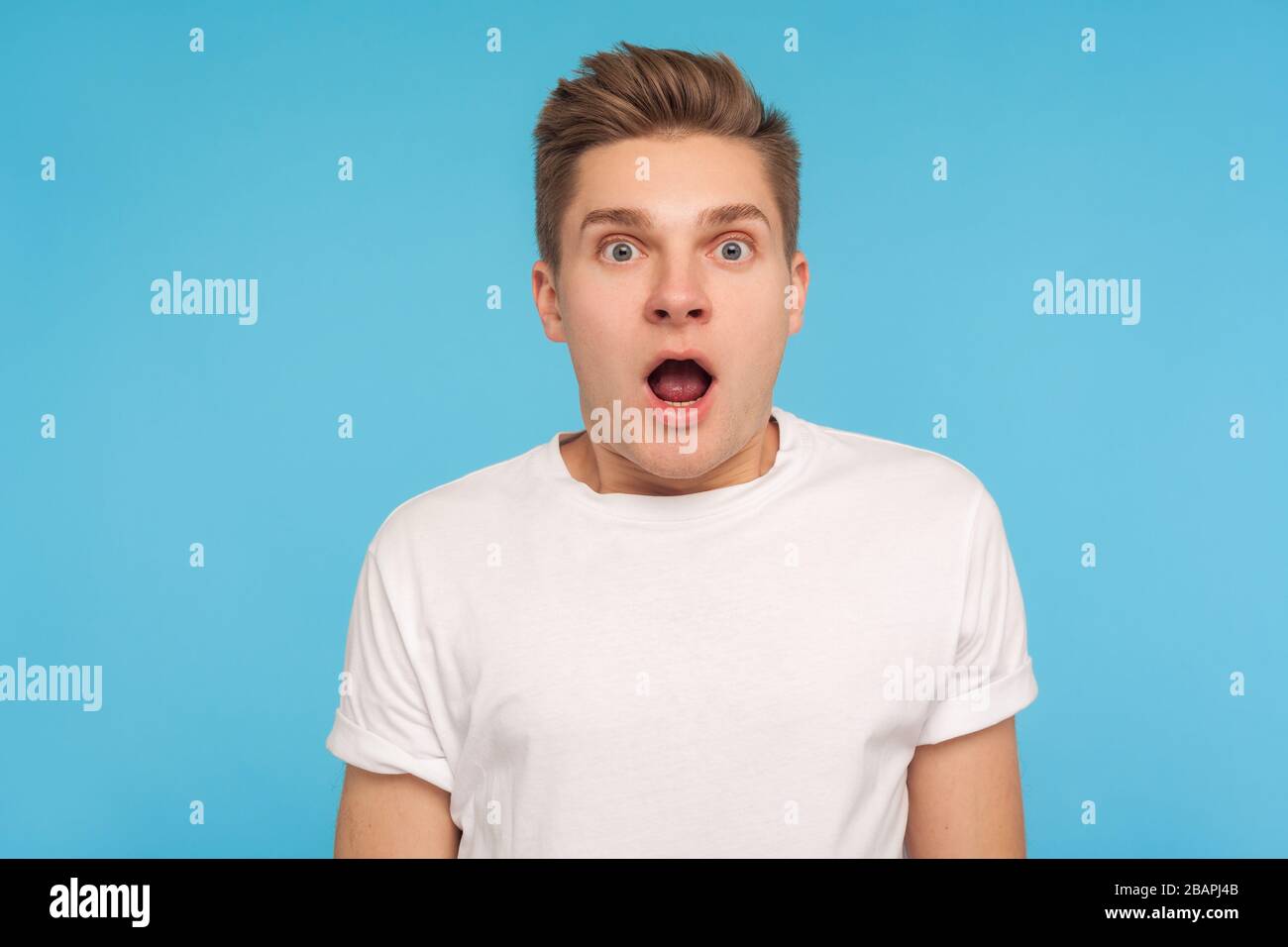 Wow, unbelievable! Portrait of astonished man in casual white t-shirt ...