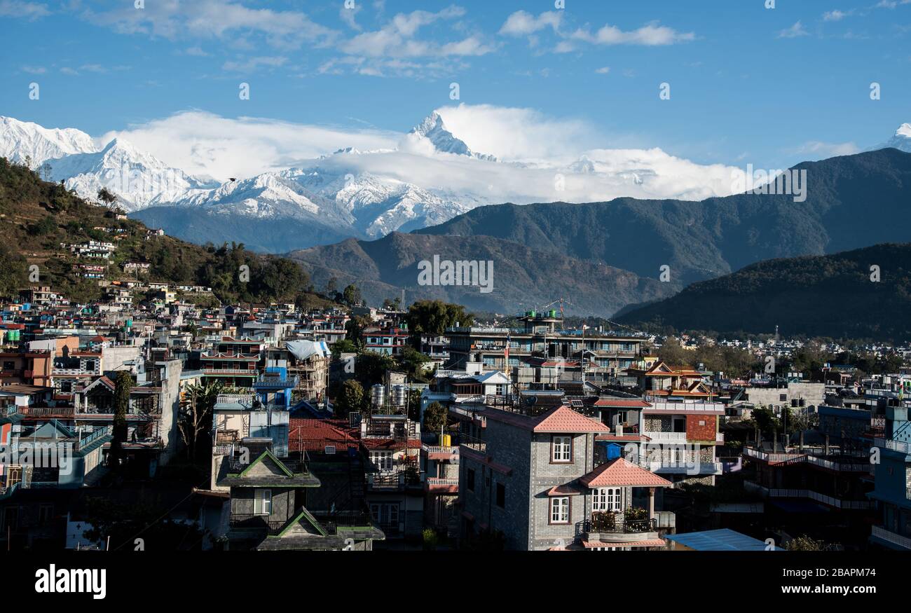 The cityscape of Pokhara with the Annapurna mountain range covered in ...