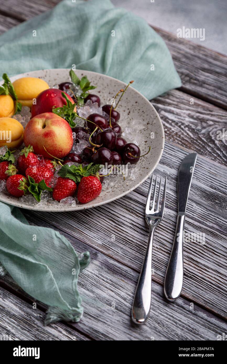 Healthy fruit platter, strawberries, apples, peaches, apricots on a ...