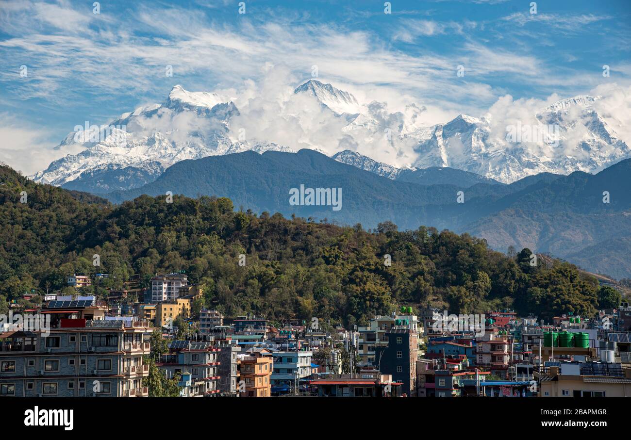 The cityscape of Pokhara with the Annapurna mountain range covered in ...