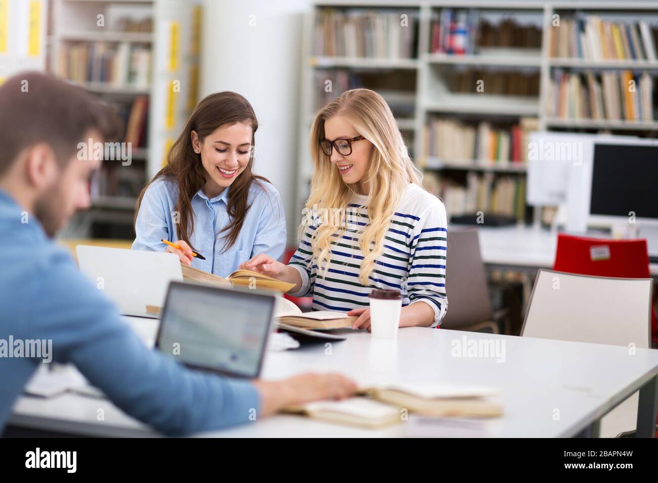 University students working in the library at campus Stock Photo - Alamy