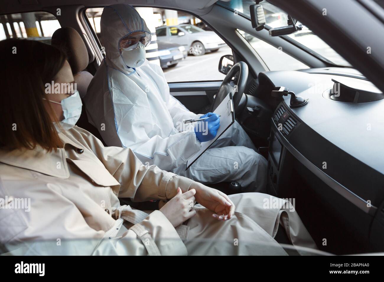 Medical worker testing woman on coronavirus symptoms Stock Photo - Alamy