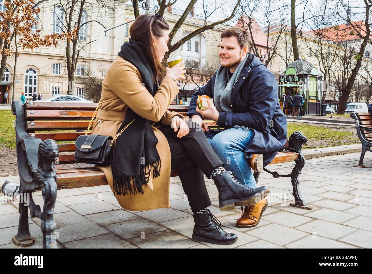 Woman eating burger bench hi-res stock photography and images - Alamy