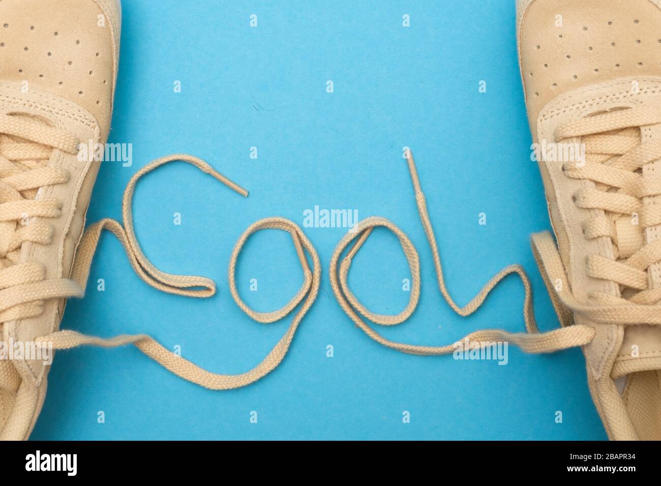 Word Cool Written With Laces Of New Shoes On Blue Background Stock word-cool-written-with-laces-of-new-shoes-on-blue-background-stock
