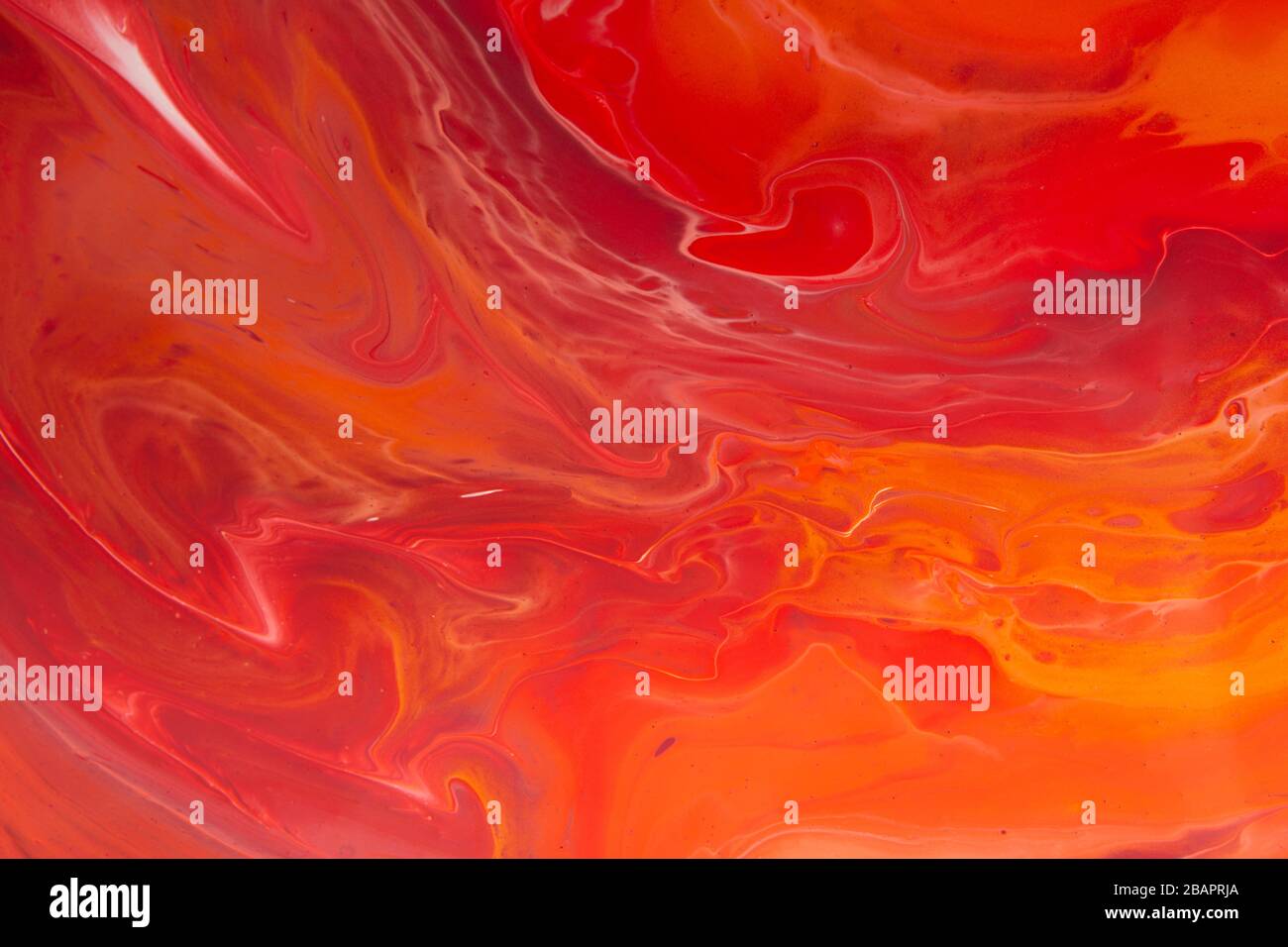 Smooth red stains liquid pouring painting technique Stock Photo - Alamy