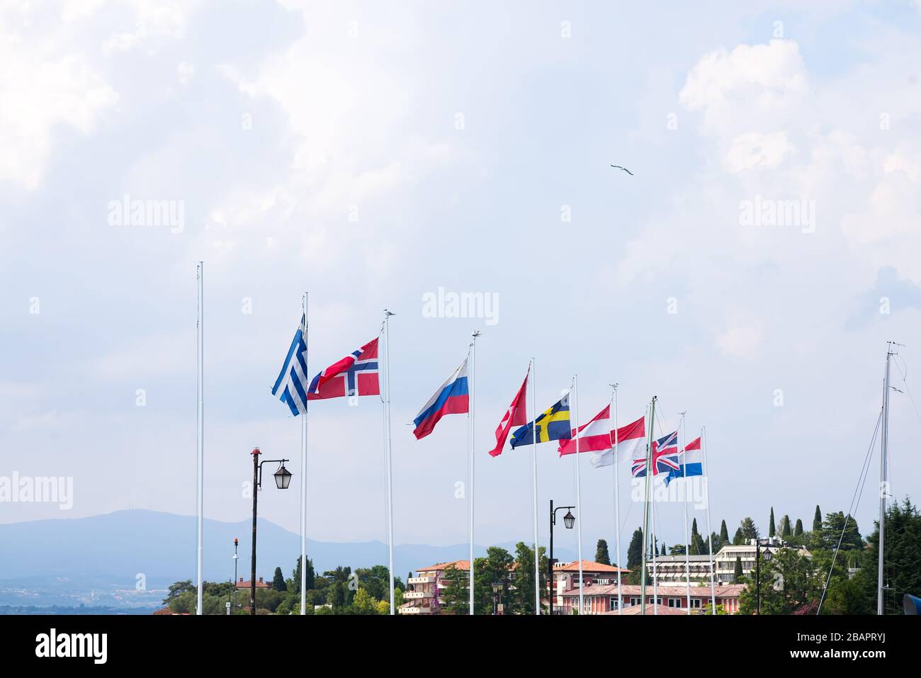 Port on Lake Garda. Flags of European countries. Summer landscape ...