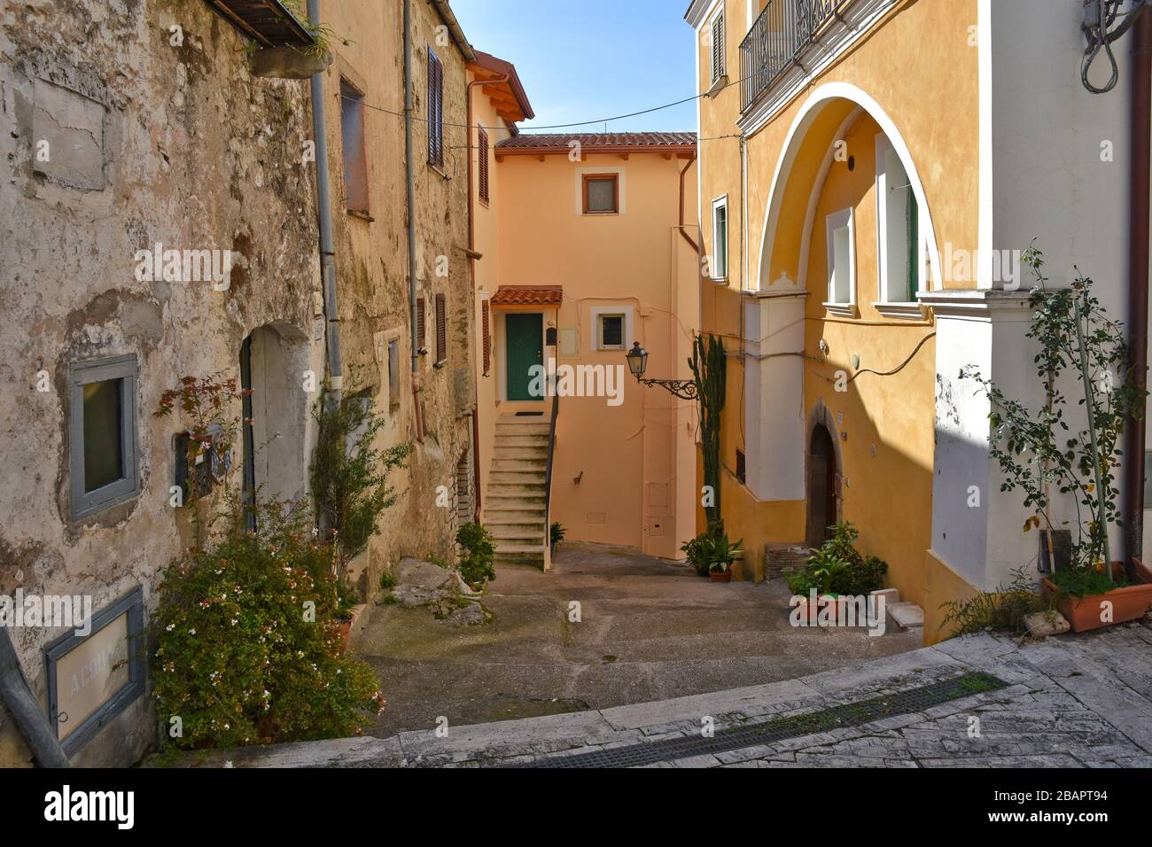 A narrow street between the stone houses of Maranola, a medieval ...
