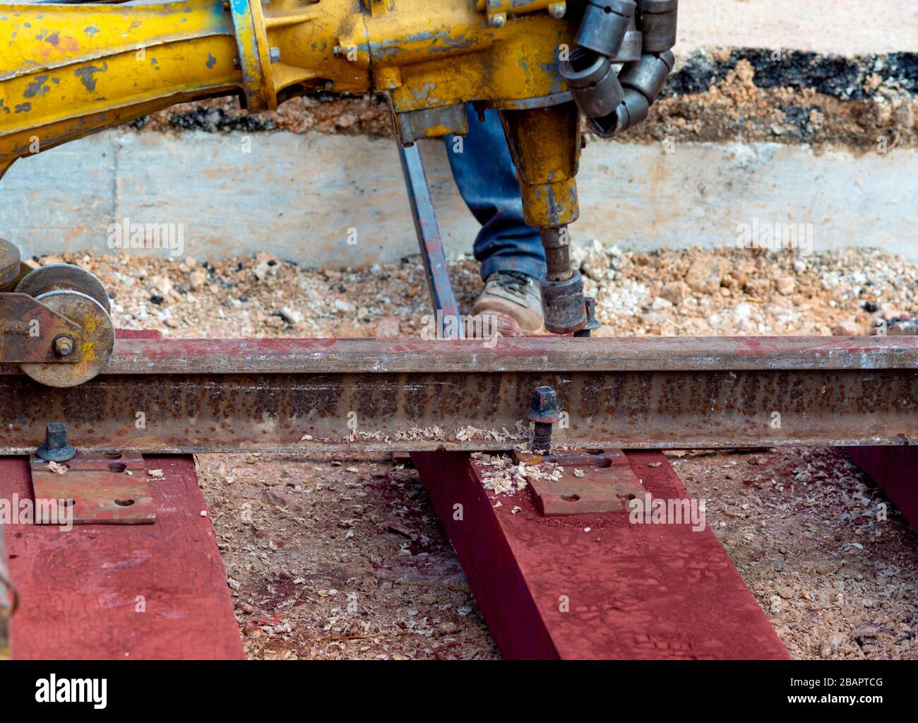 Railway workers bolting track rail. Detail worker with Light portable ...