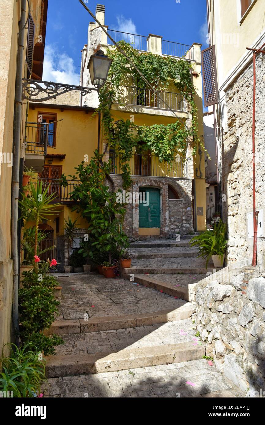 A narrow street between the stone houses of Maranola, a medieval ...