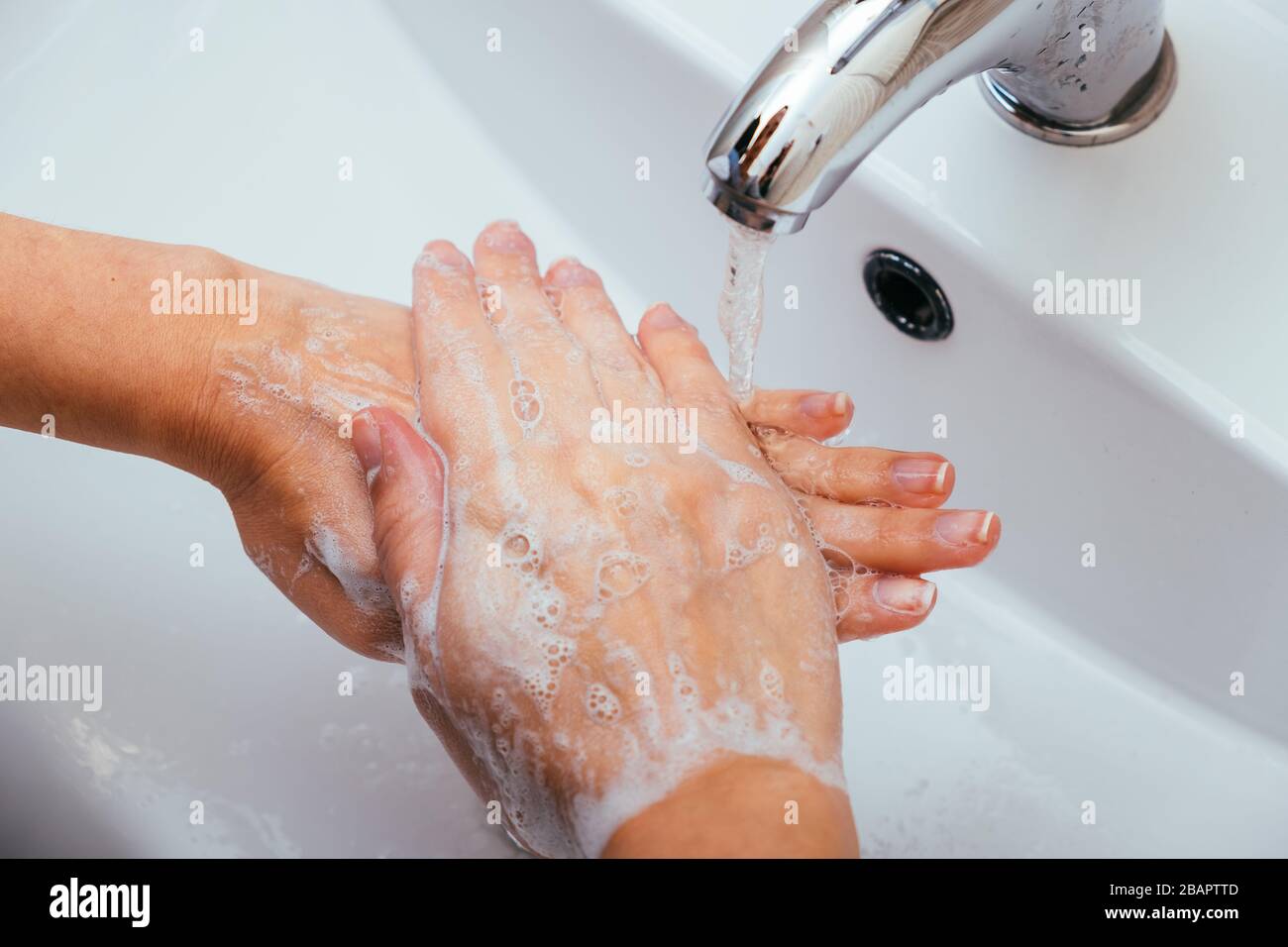 Woman Washing her hands with soap and water at home bathroom. Cleansing ...