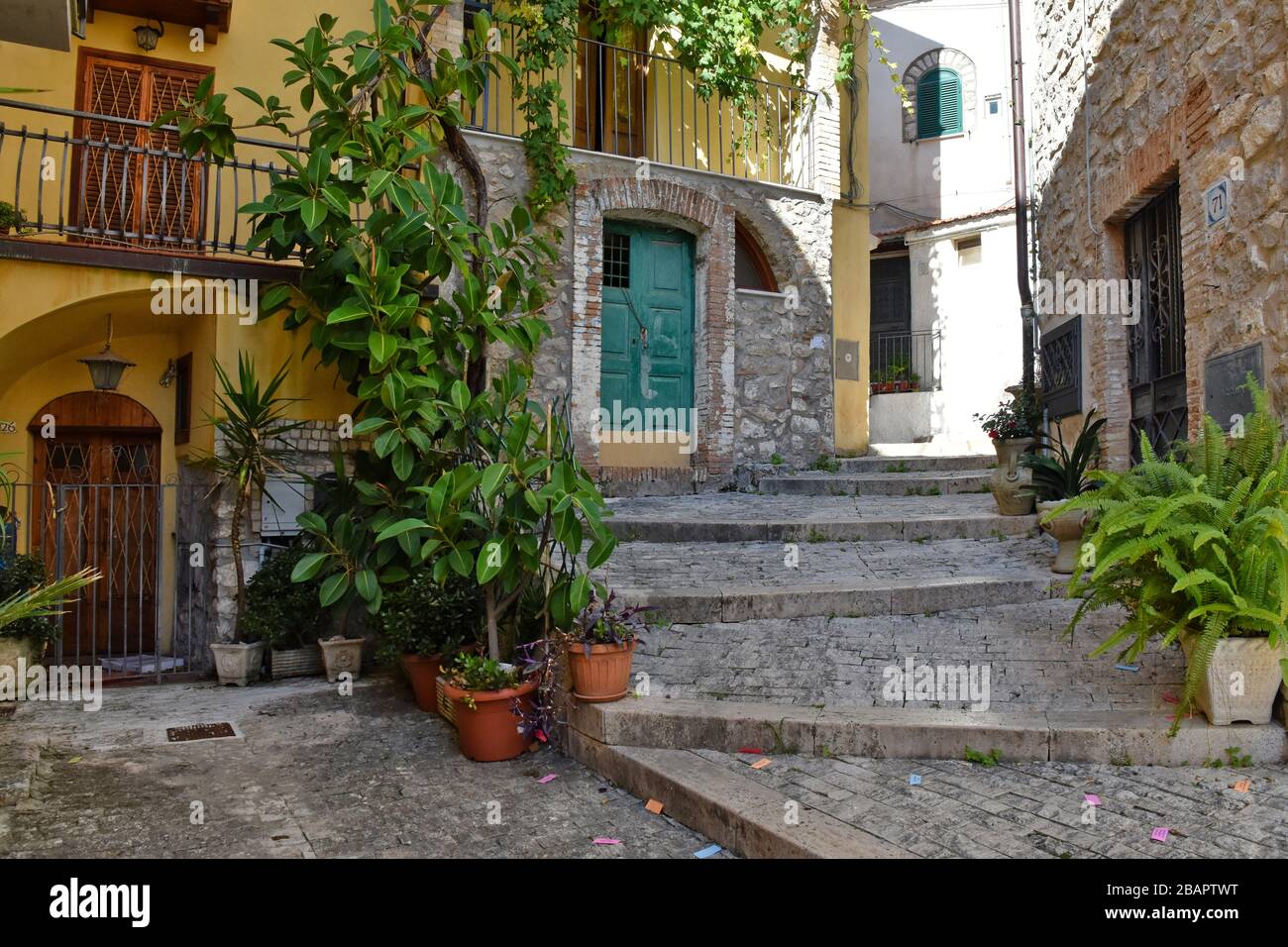 A narrow street between the stone houses of Maranola, a medieval ...