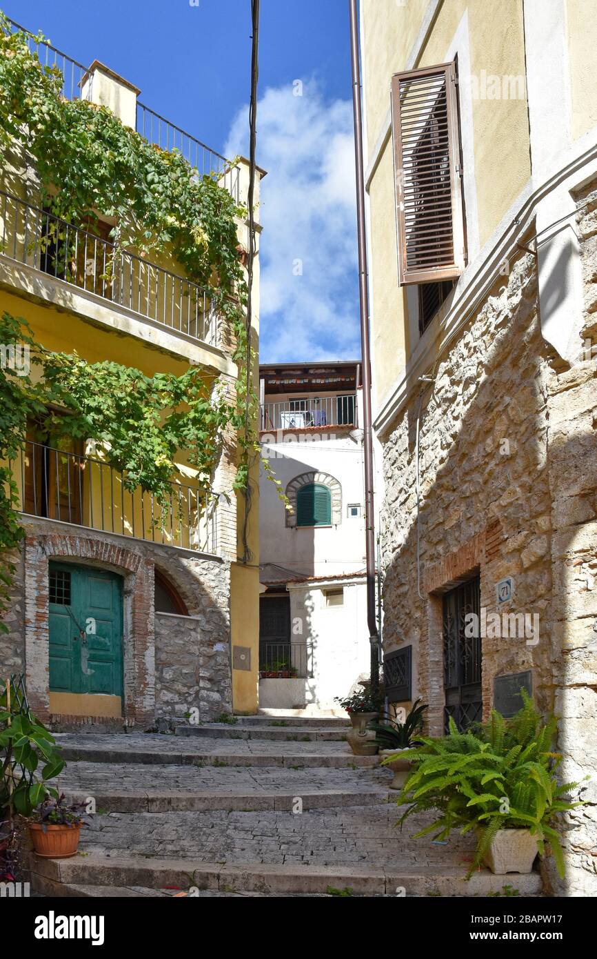 A narrow street between the stone houses of Maranola, a medieval ...