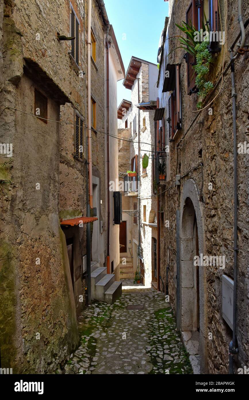 A narrow street between the stone houses of Maranola, a medieval ...