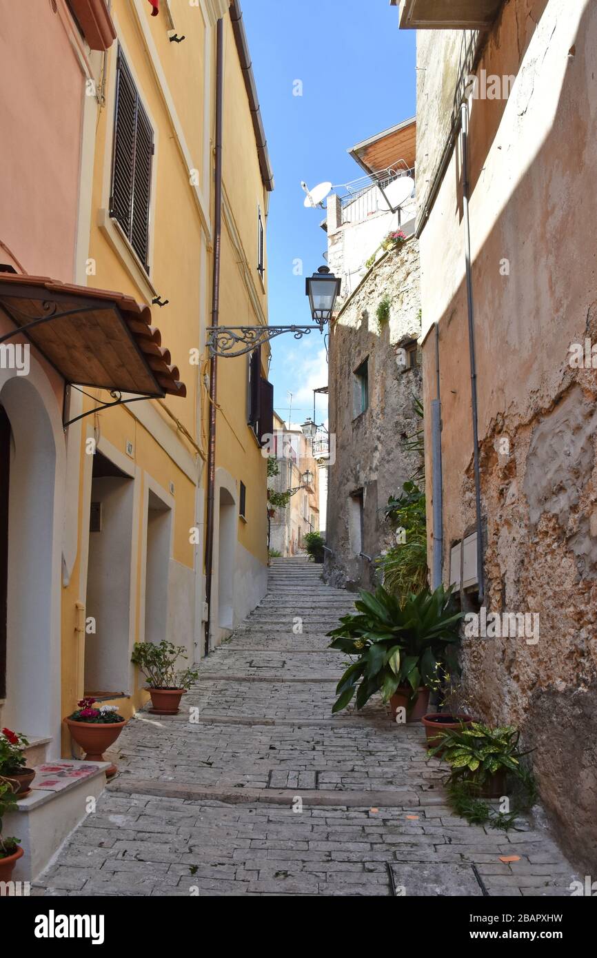 A narrow street between the stone houses of Maranola, a medieval ...