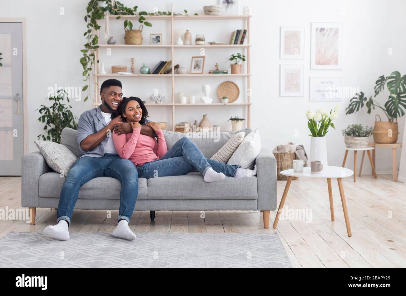 Attractive couple cuddling on couch hi-res stock photography and images ...