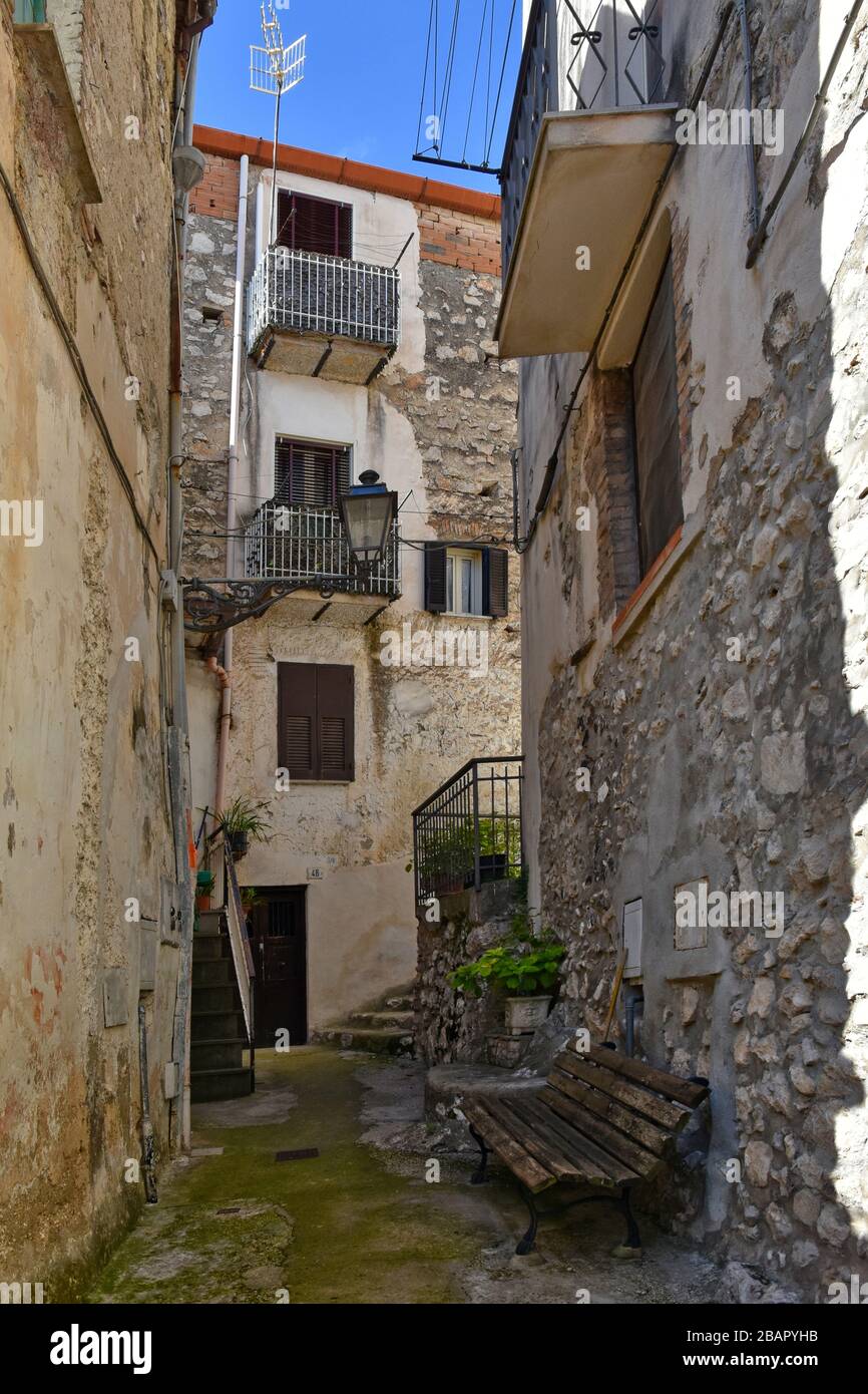 A narrow street between the stone houses of Maranola, a medieval ...
