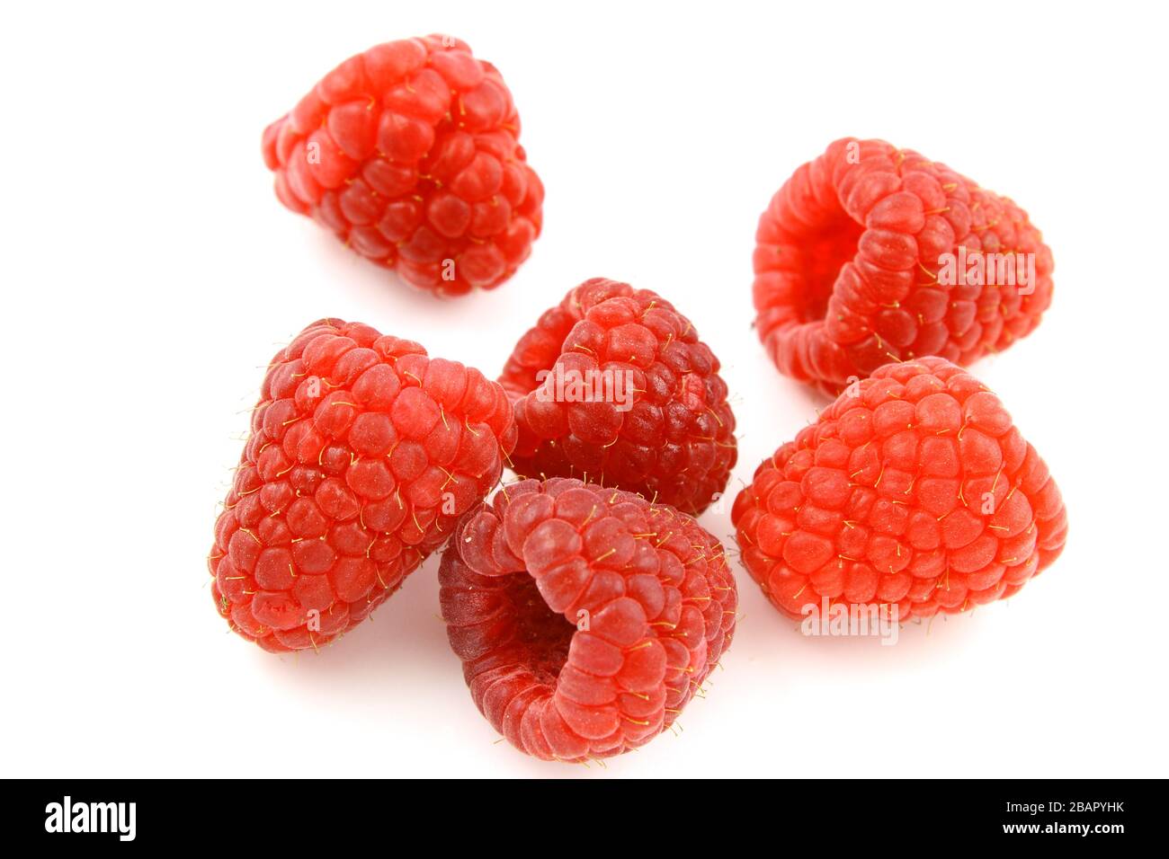 composition of fresh red raspberry fruits isolated on a white ...