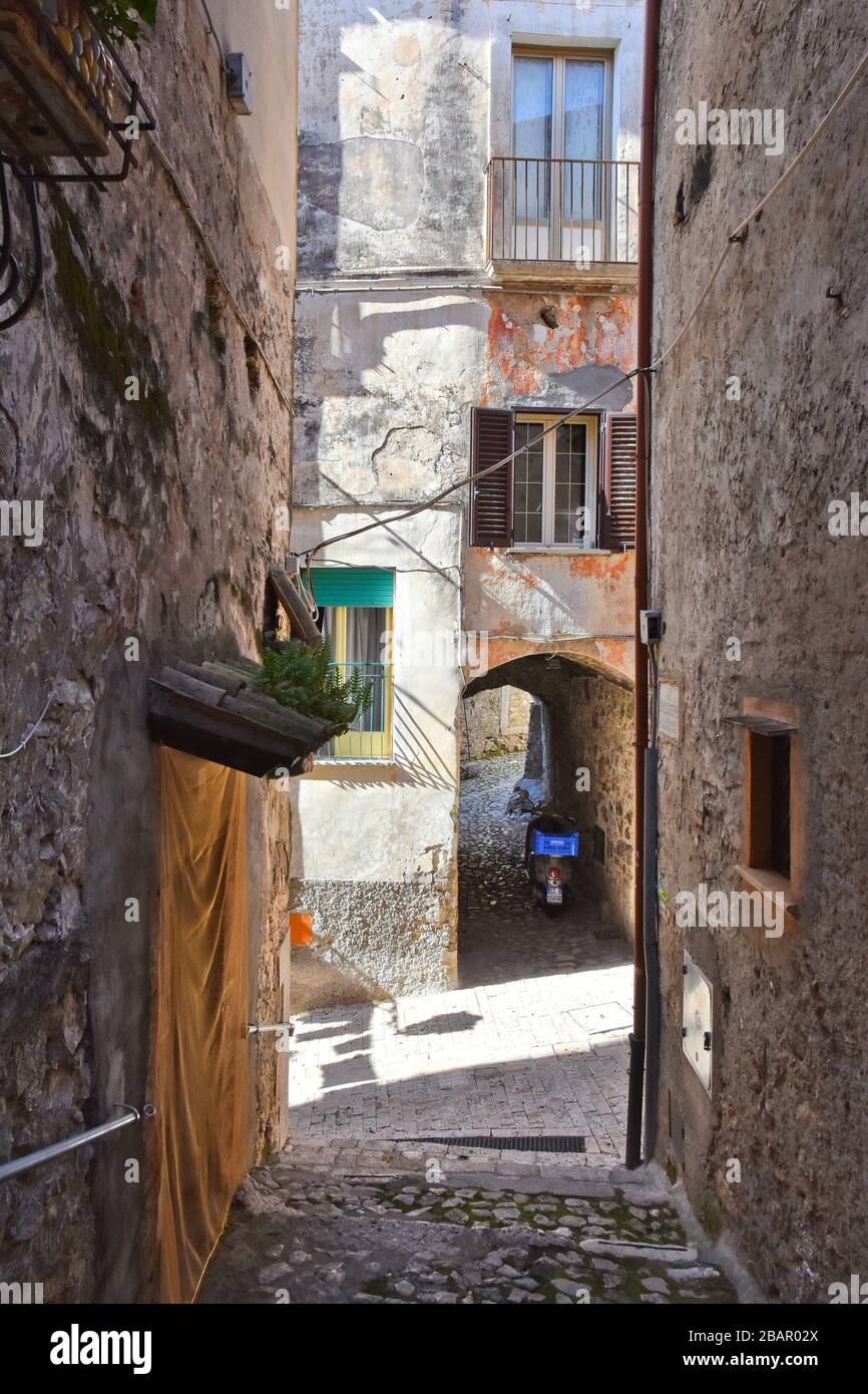 A narrow street between the stone houses of Maranola, a medieval ...