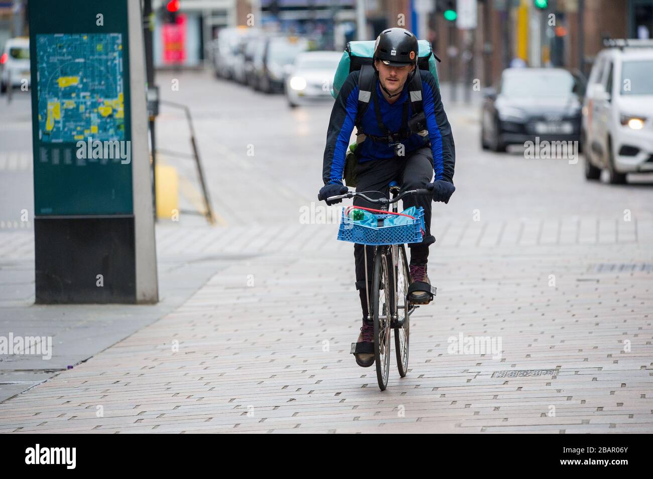 Deliveroo delivery man delivers food on his bike hi-res stock ...
