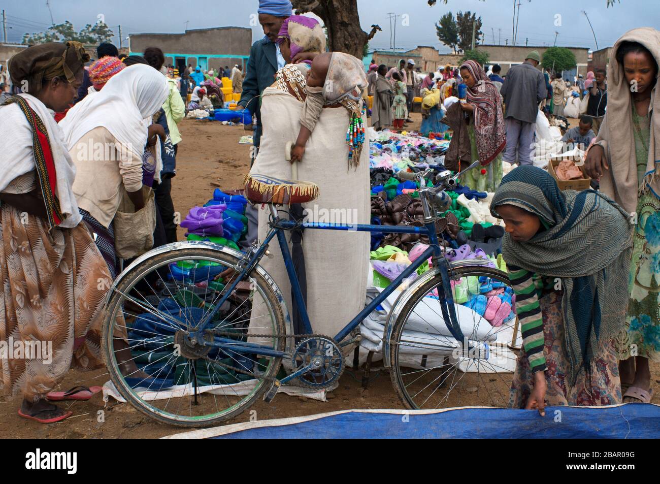 Vendors sell produce at the public market in the town of Hawzen, Tigray ...