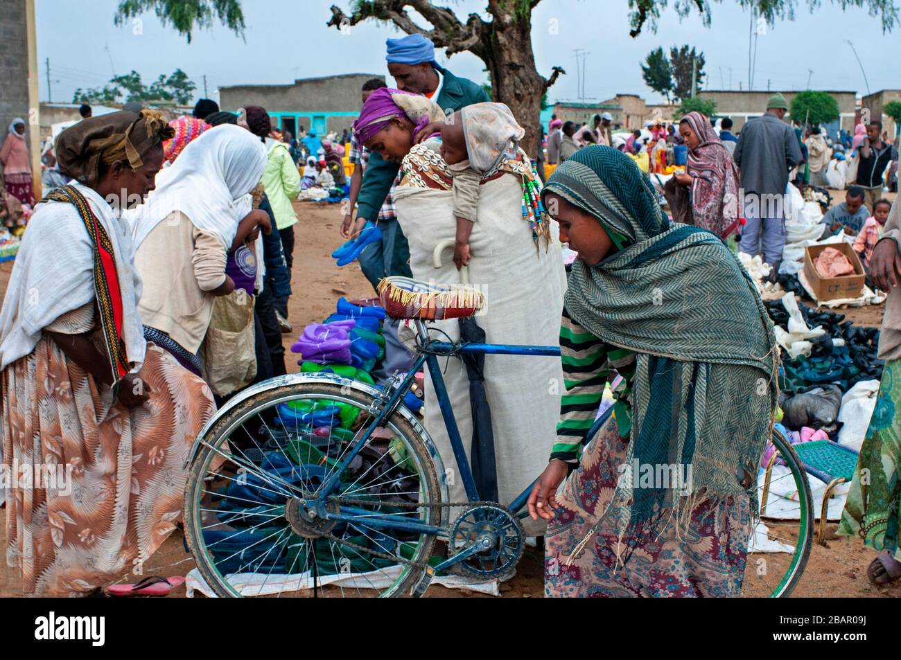 Vendors sell produce at the public market in the town of Hawzen, Tigray ...