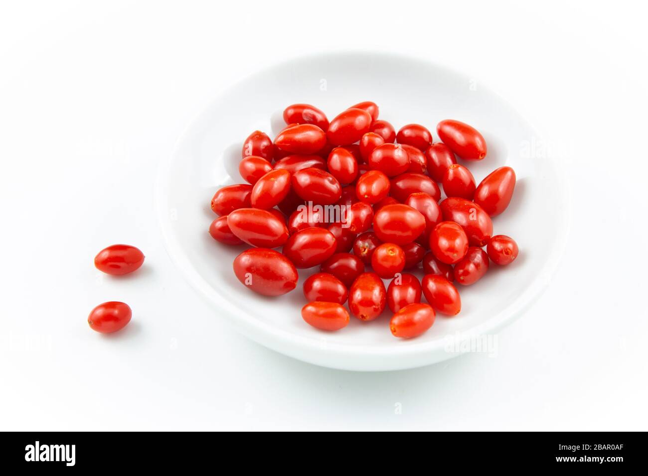 fresh goji berries in a small white bowl isolated on white copy space ...