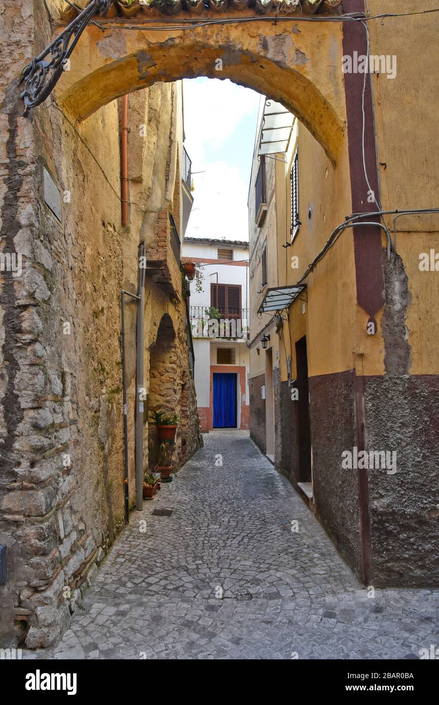 A narrow street between the stone houses of Maranola, a medieval ...